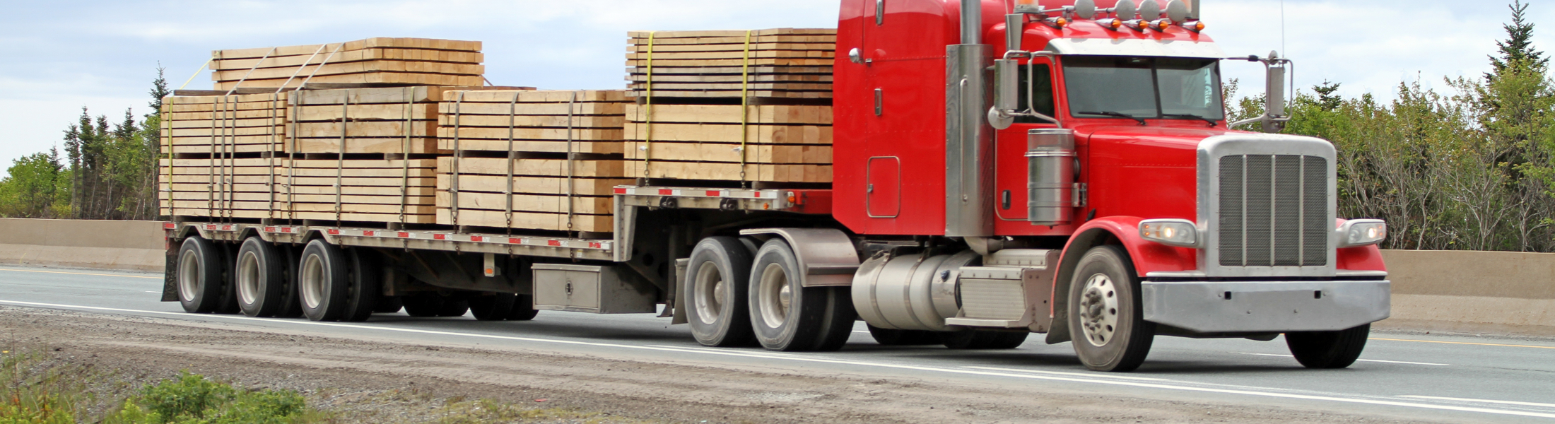 Semi Flatbed Truck Hauling A Load Of Lumber To A Construction Site ...